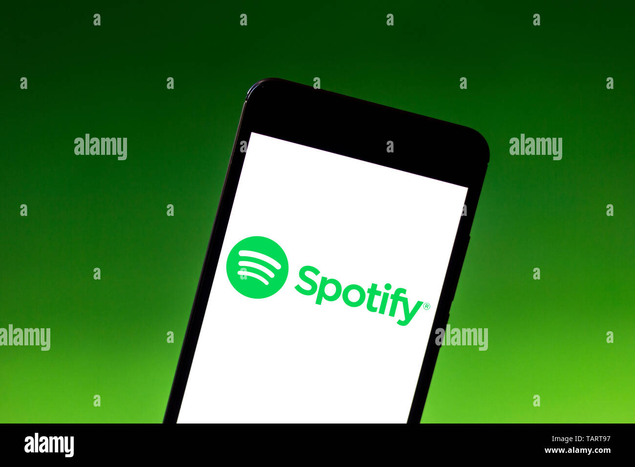 In this photo illustration the Spotify logo is seen displayed on a ...