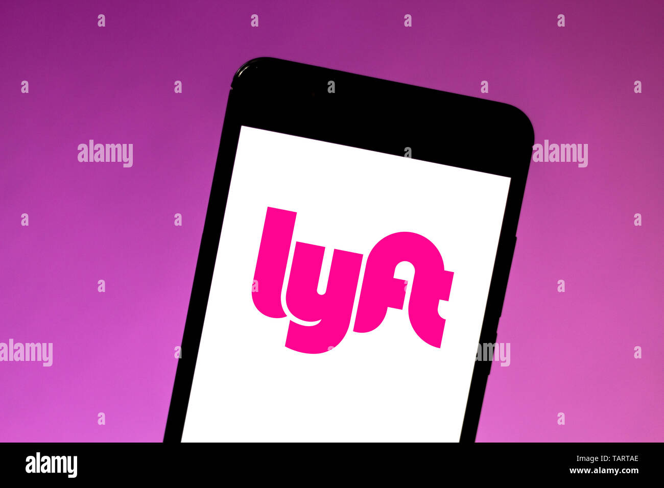 In this photo illustration the Lyft logo is seen displayed on a ...