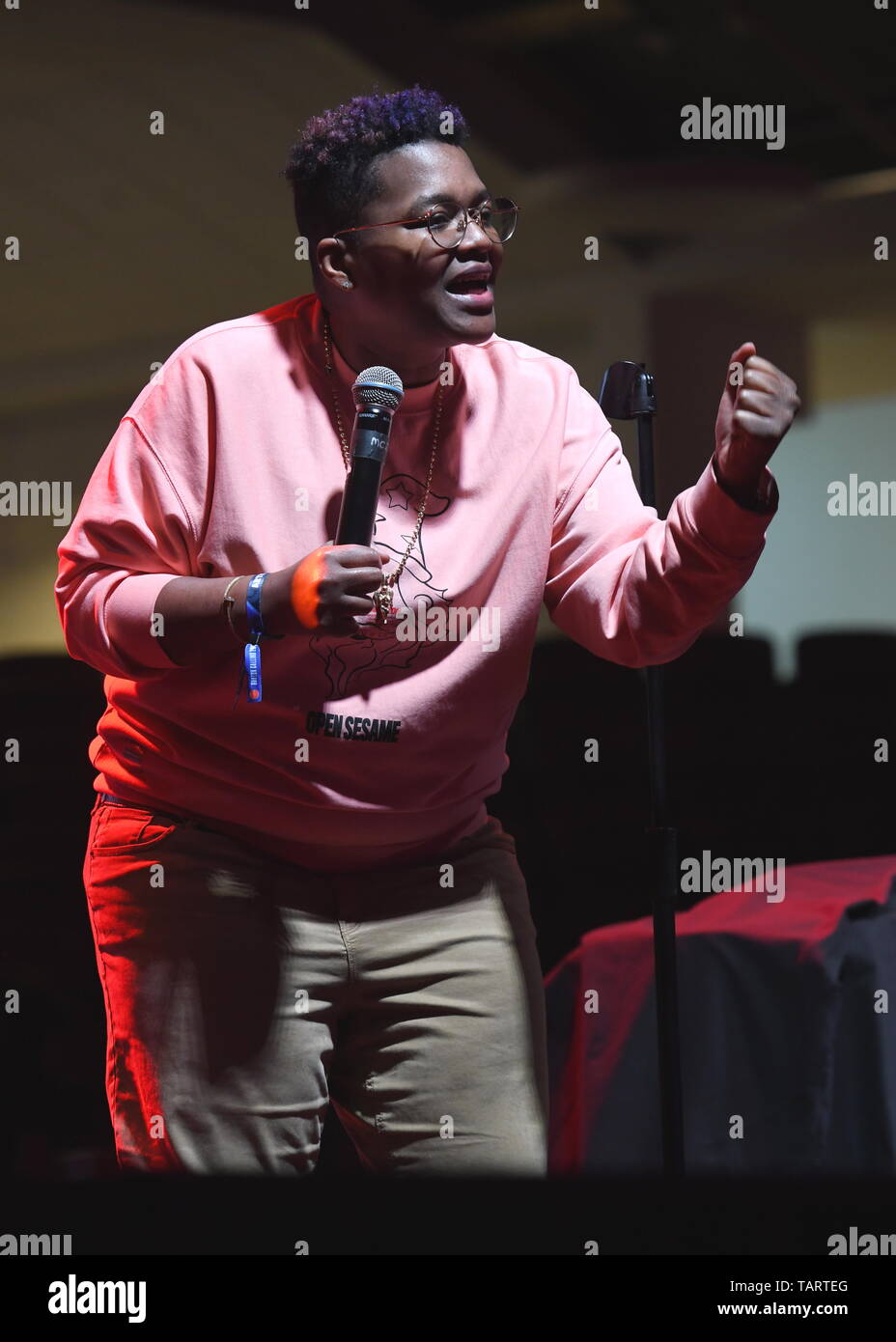 Comedian Sam Jay is shown performing on stage during a "live" stand up ...
