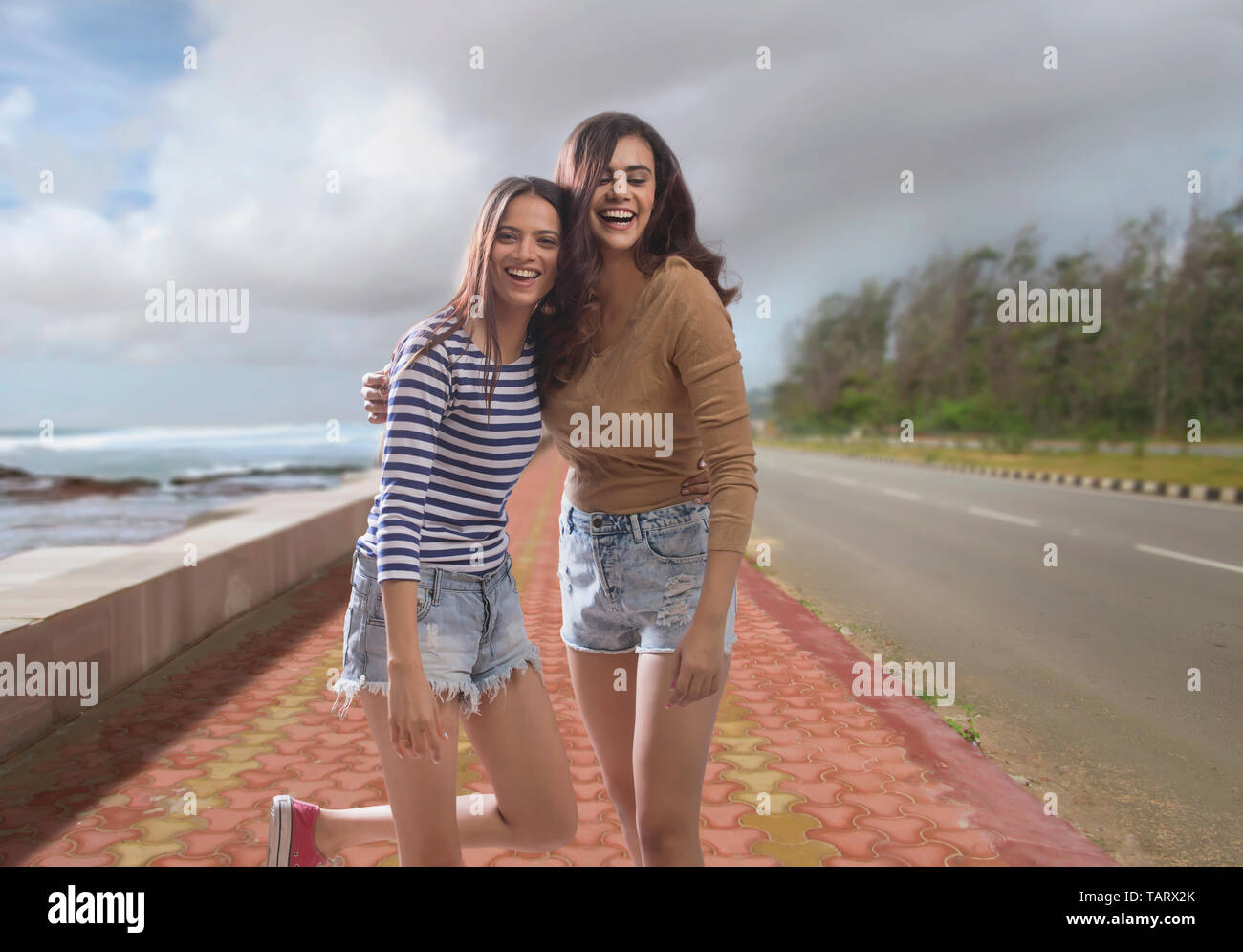 Two women walking pavement hi-res stock photography and images - Alamy