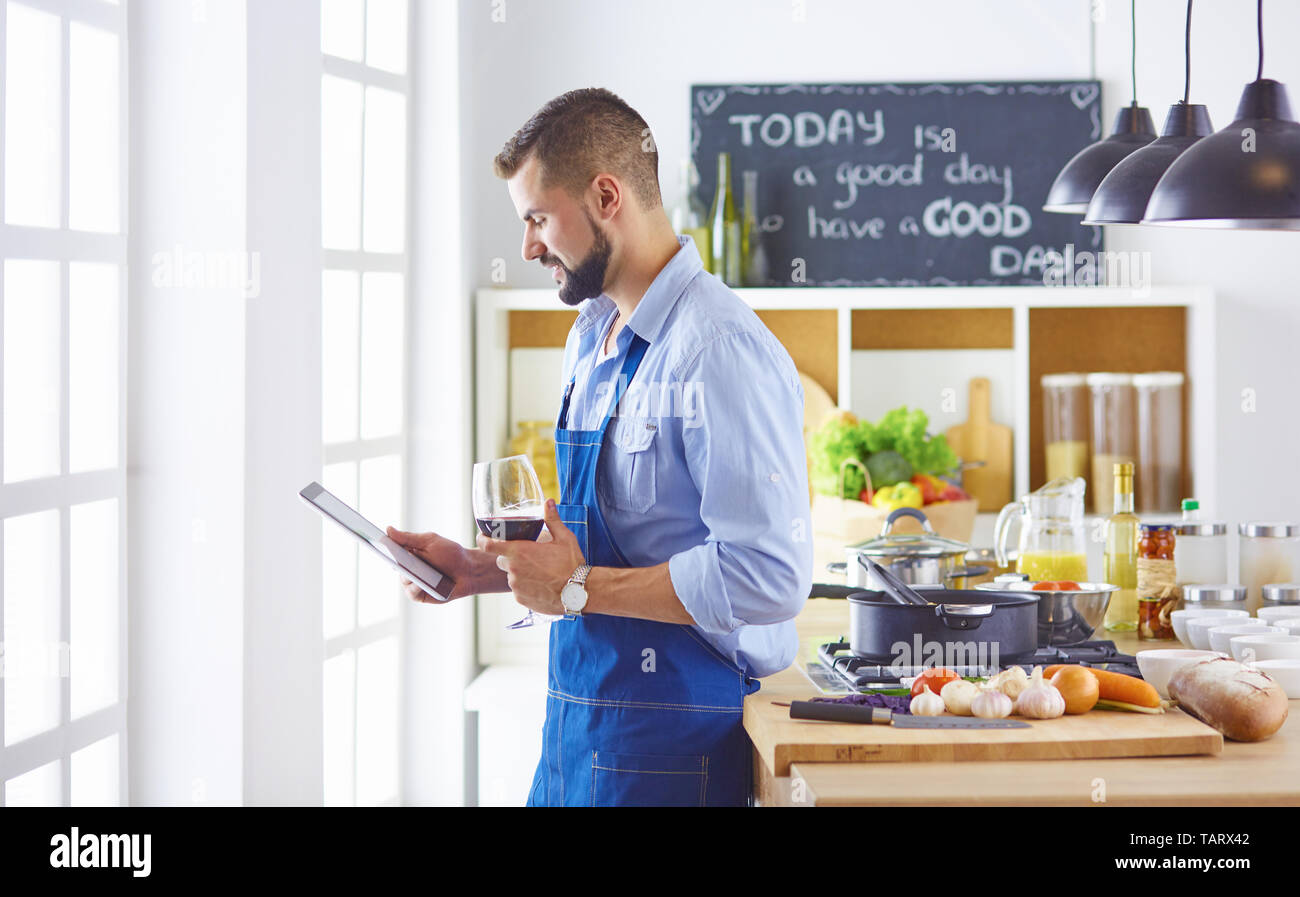 cook with a tablet in hand and studying the recipe Stock Photo - Alamy