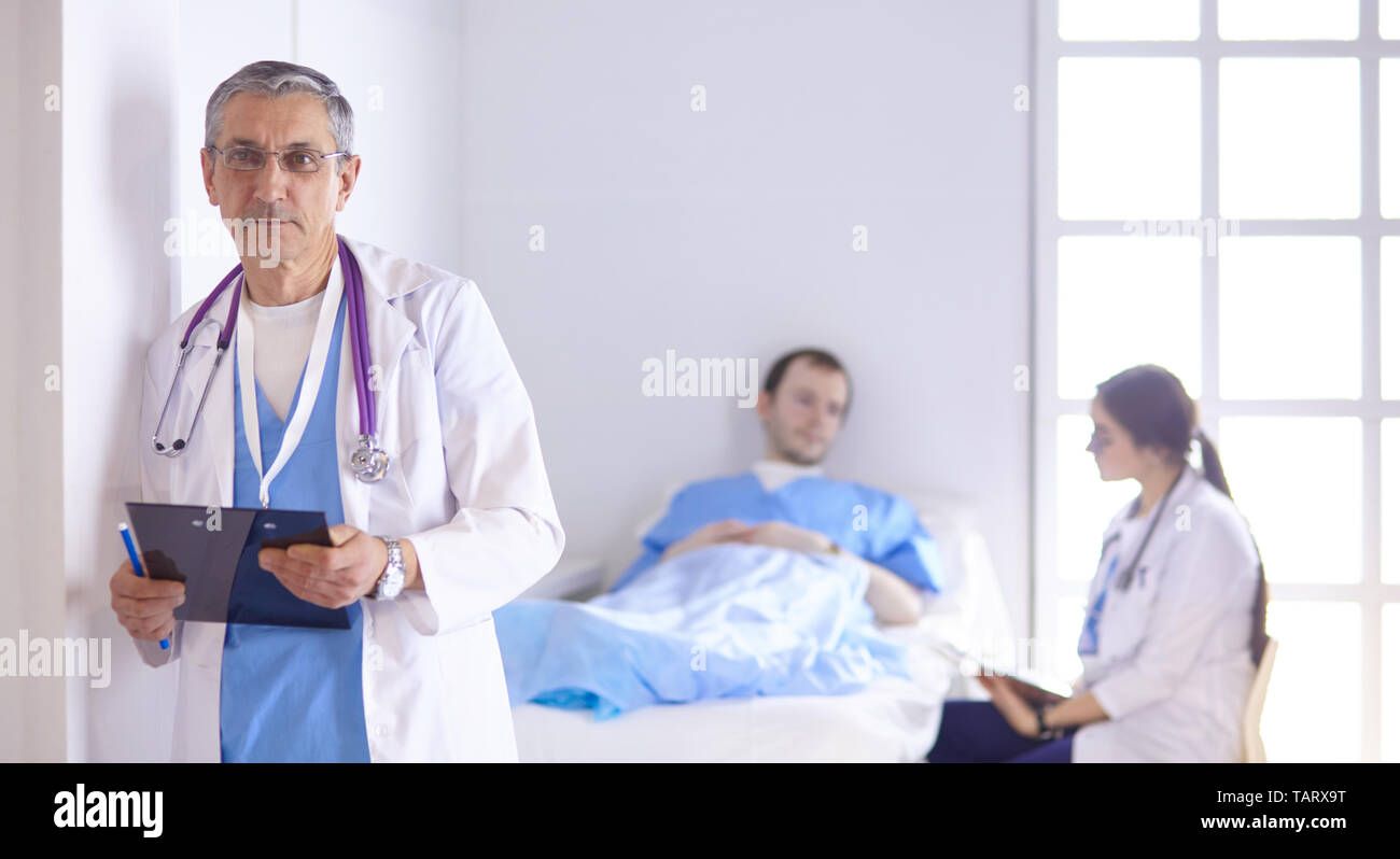 Doctor checking heart beat of patient in bed with stethoscope Stock ...