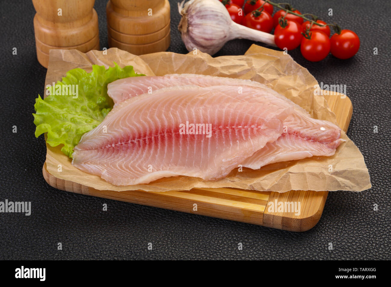 Raw tilapia fish ready for cooking Stock Photo - Alamy