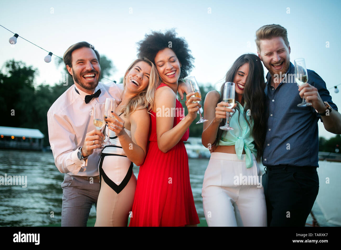 Group of friends having fun and celebrating group gathering Stock Photo ...