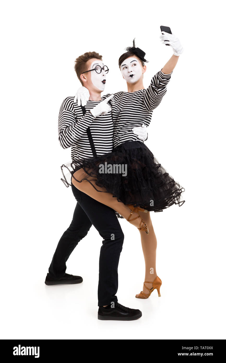 Smiling mimes in striped shirts. couple mimes making selfie on camera ...