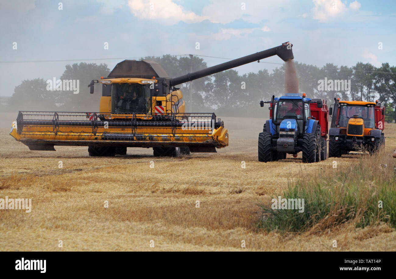 Field and harvester Stock Photo - Alamy