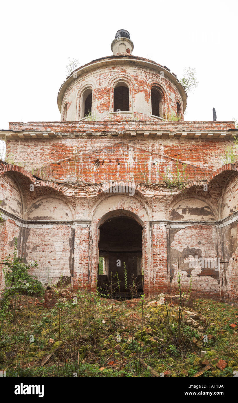 Ruins of old abandoned church. Building with collapsed vault is covered ...