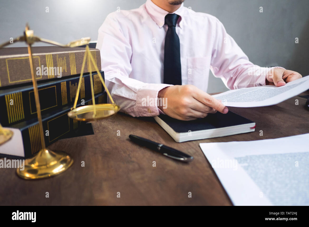 lawyer judge reading documents at desk in courtroom working on wooden ...