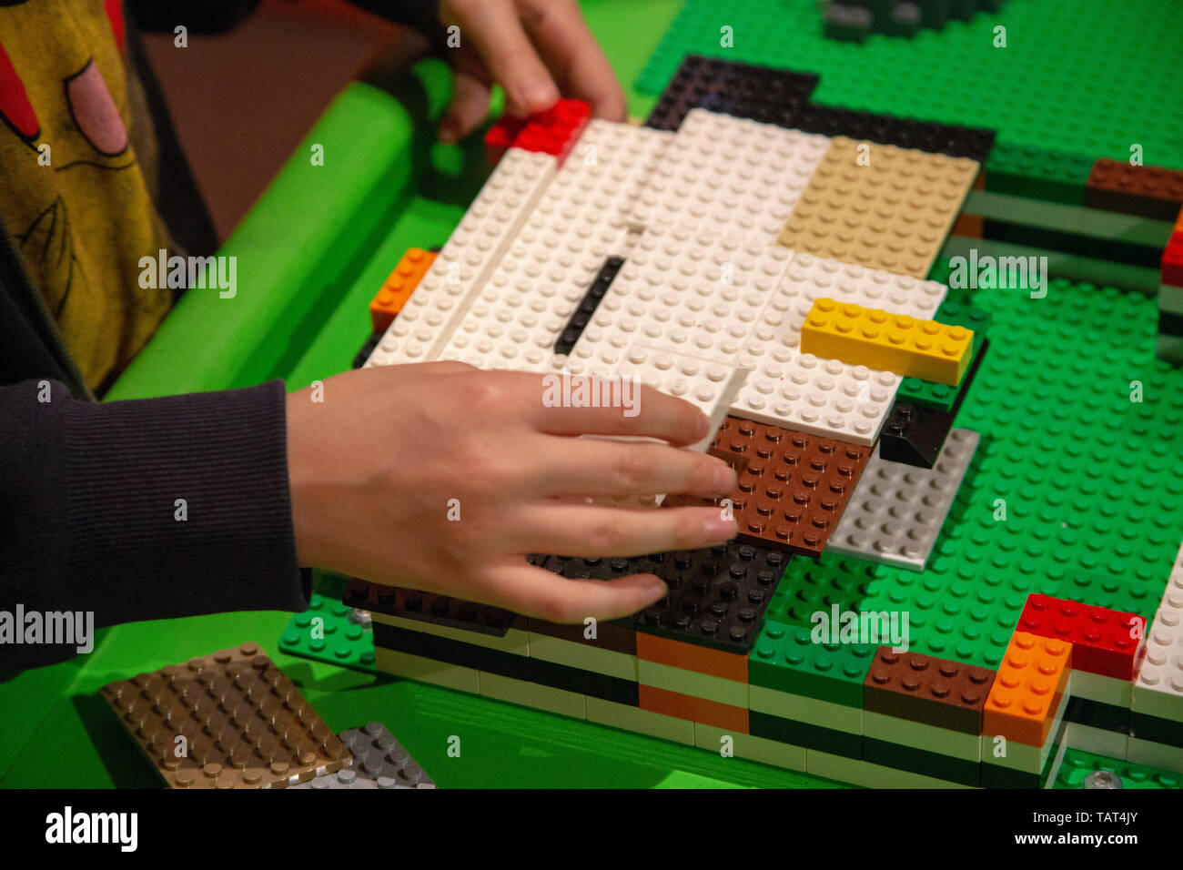 Child's hands building with Lego bricks Stock Photo - Alamy