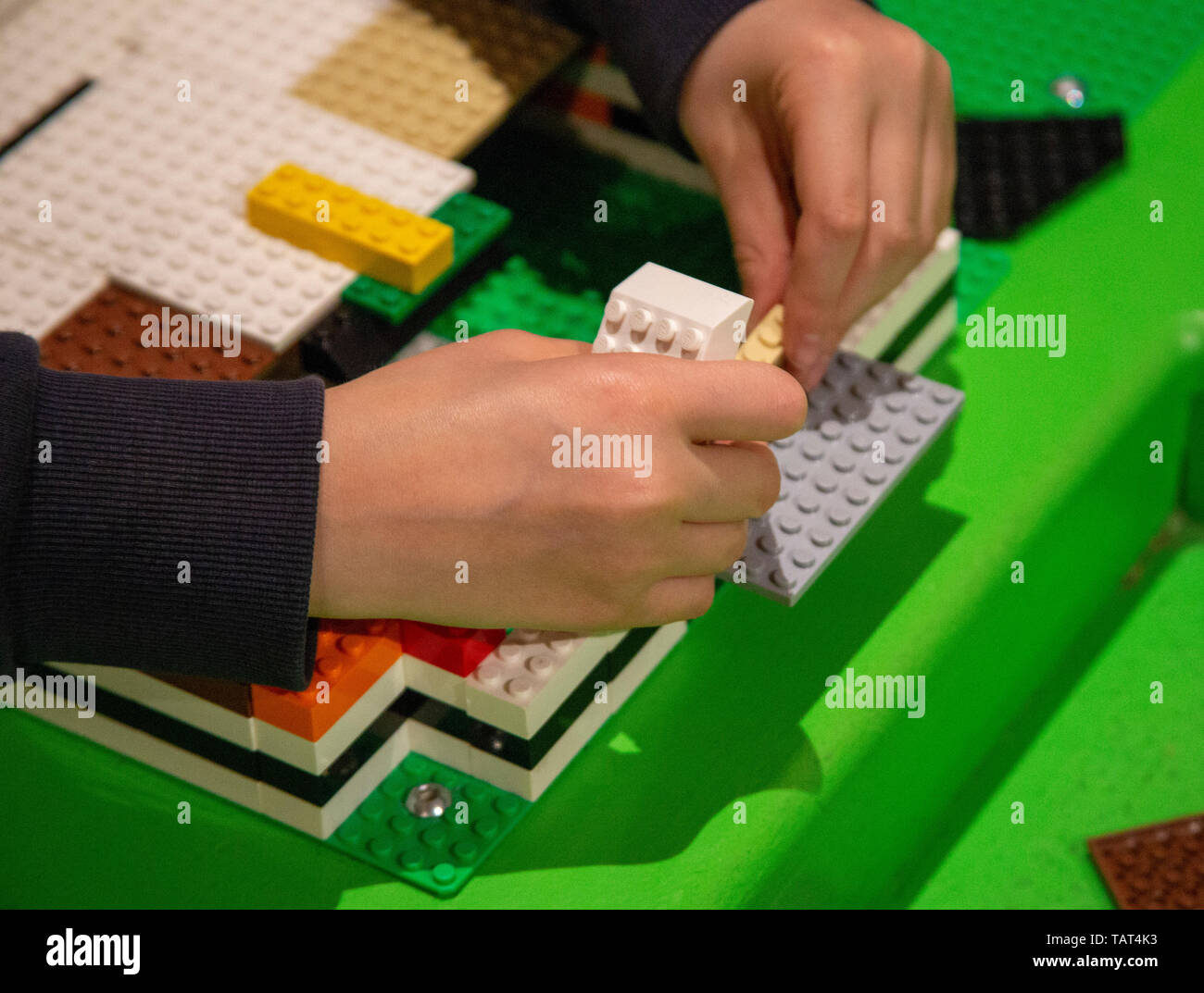 Child's hands building with Lego bricks Stock Photo - Alamy