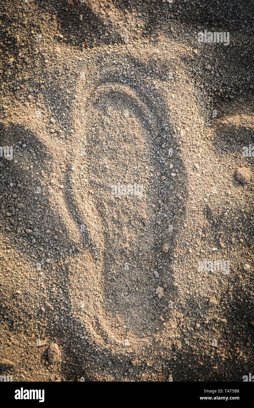 Shoe track on sand / Imprint footprint on ground traces of feet texture ...