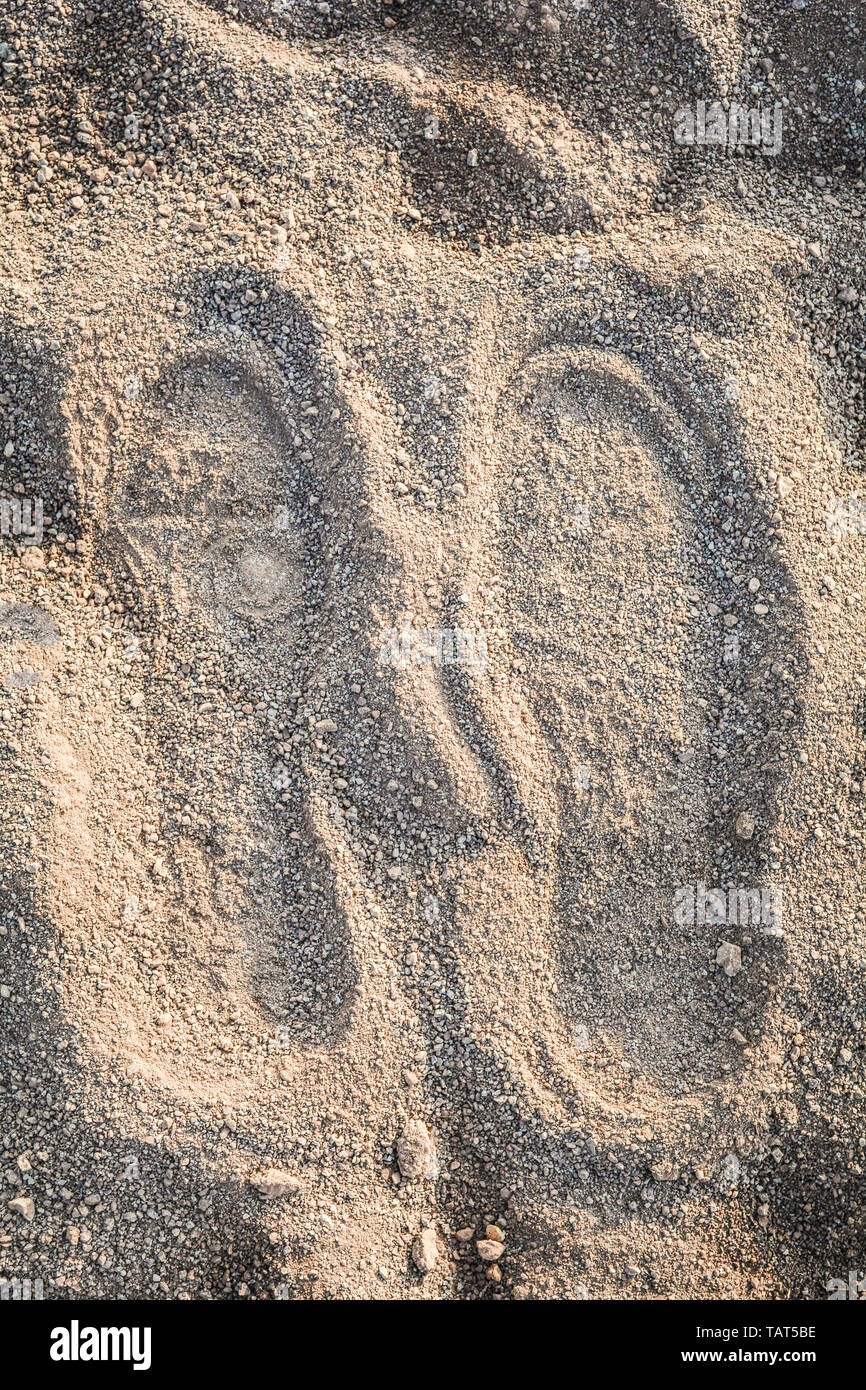 Shoe track on sand / Imprint footprint on ground traces of feet texture ...