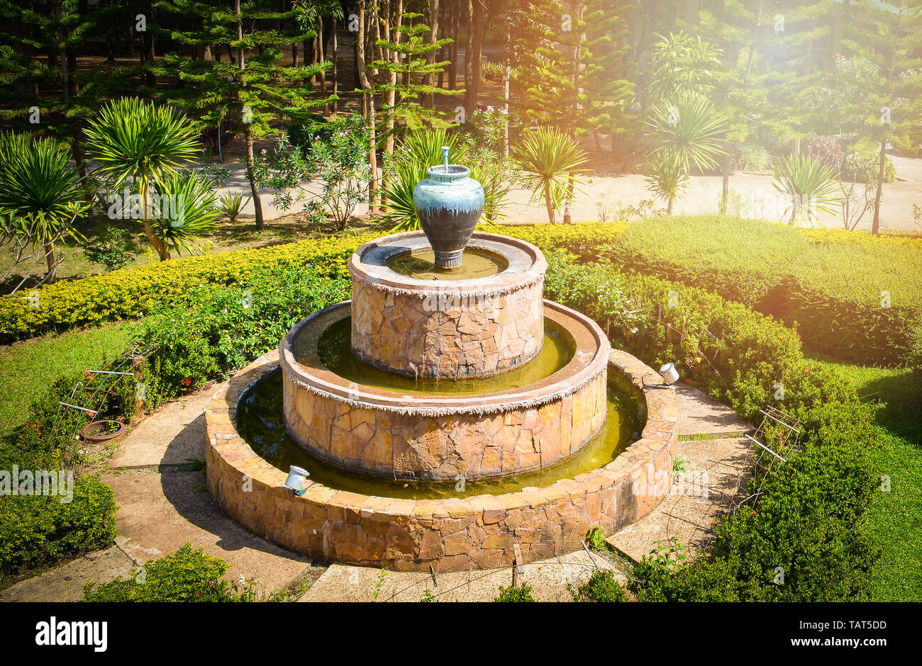 Beautiful of garden walkway decorate with plant and the fountain spring ...