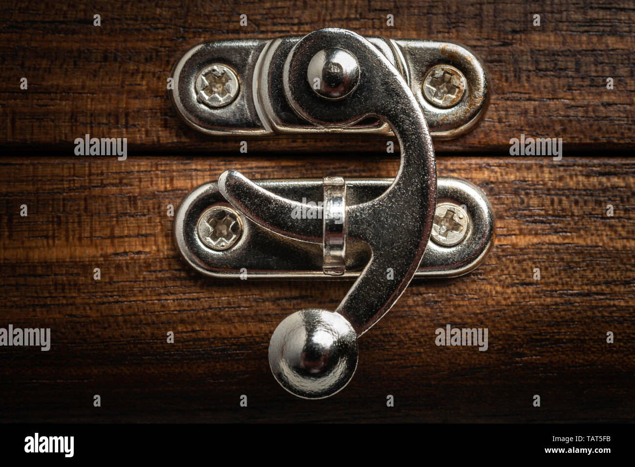 A close-up frontal view of a fancy silver-color sliding latch lock for ...