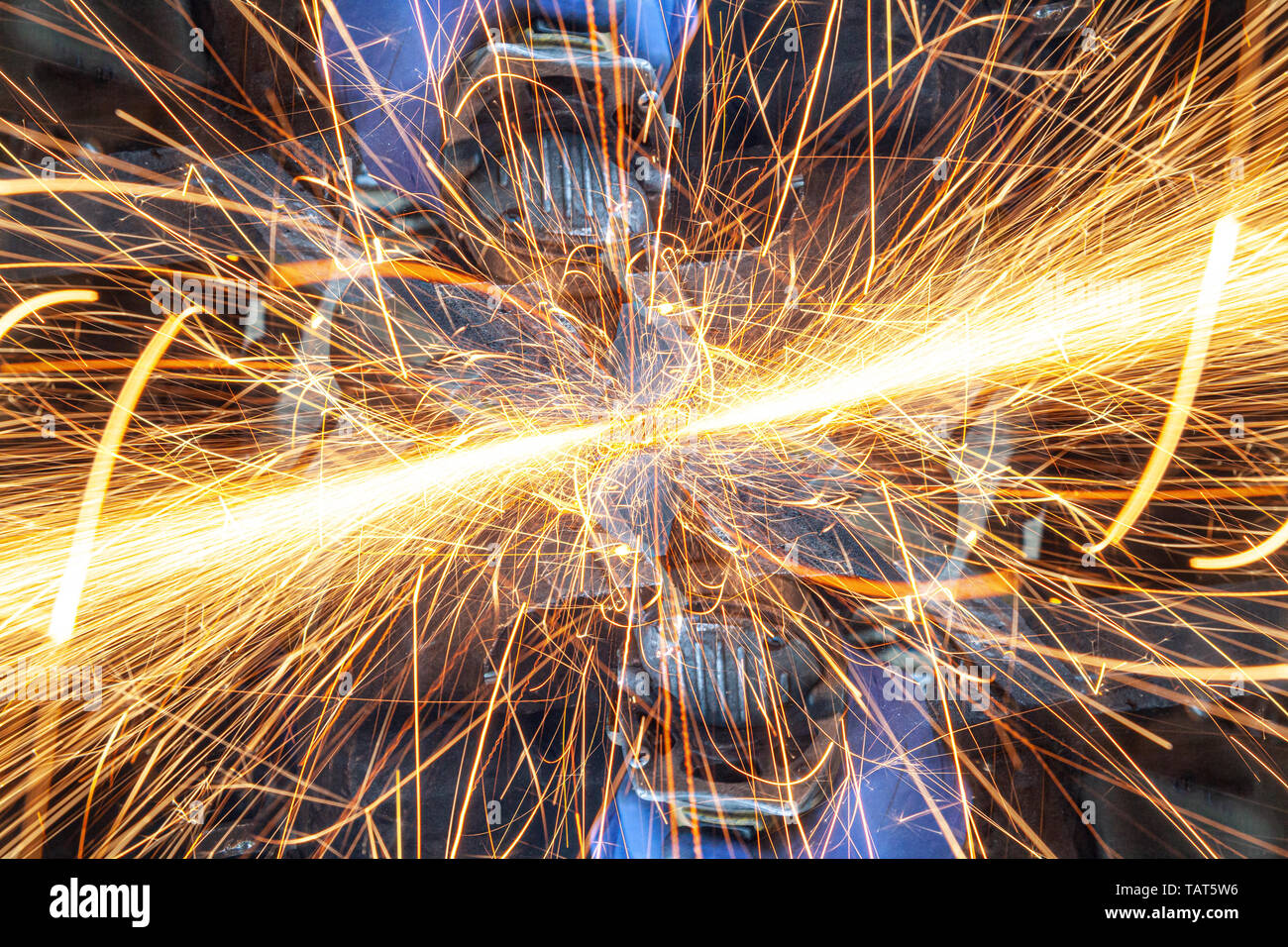 sparks flying while machine griding and finishing metal Stock Photo - Alamy
