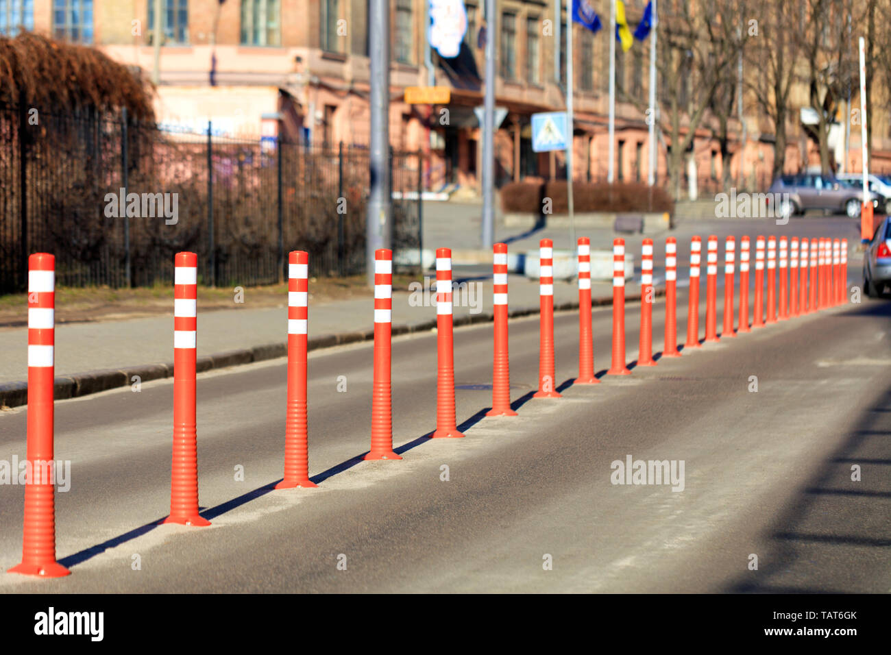 Red reflective road columns divide the road in half against the ...