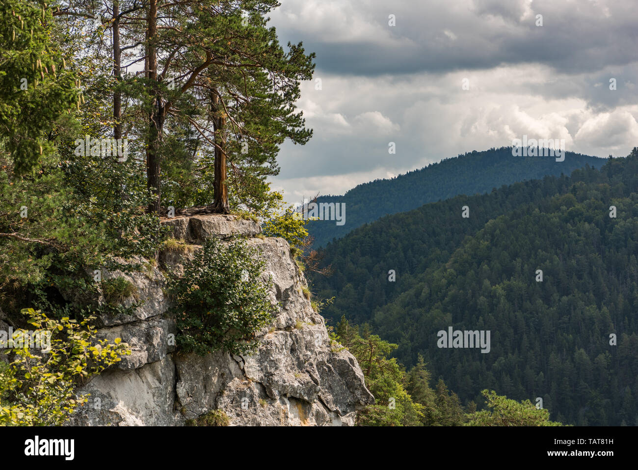 Rocky cliff, dark clouds and freen mountains from Tomasovsky vyhlad ...