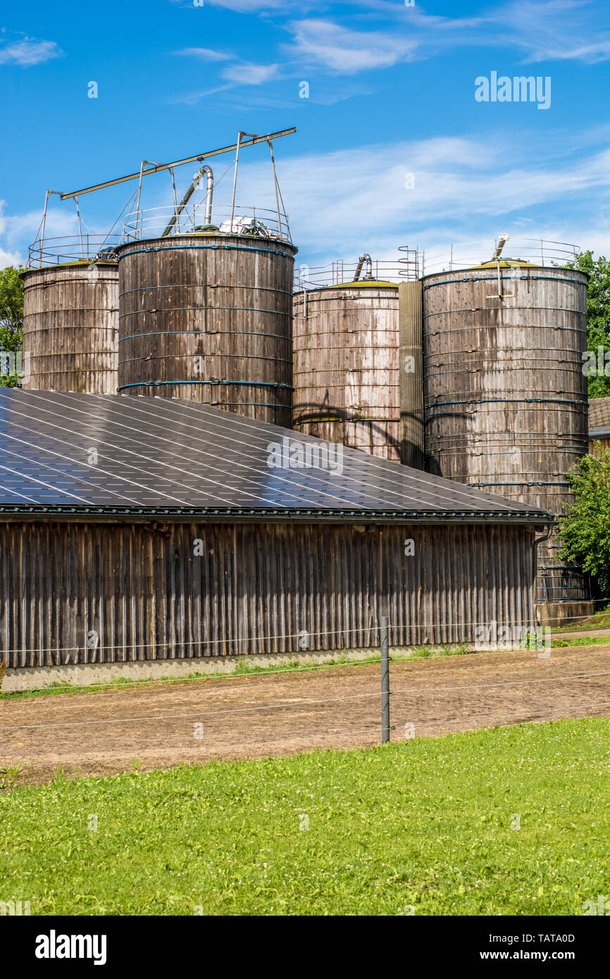 Grain silos and feed silos on an old farm with modern photovoltaic ...