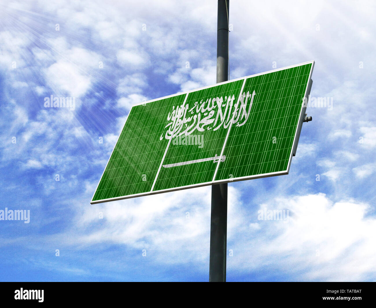 Solar panels against a blue sky with a picture of the flag of Saudi ...