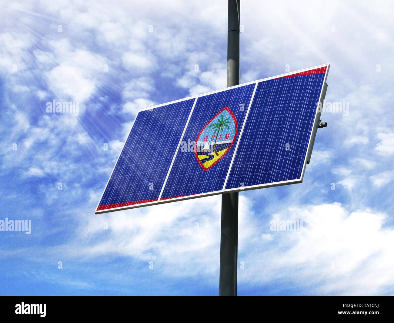 Solar panels against a blue sky with a picture of the flag of Guam ...