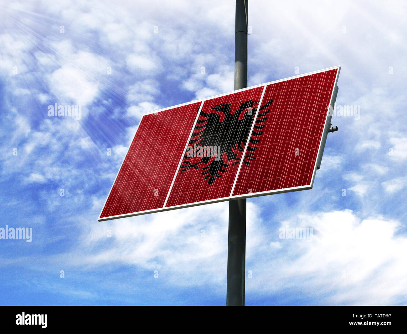 Solar panels against a blue sky with a picture of the flag of Albania ...