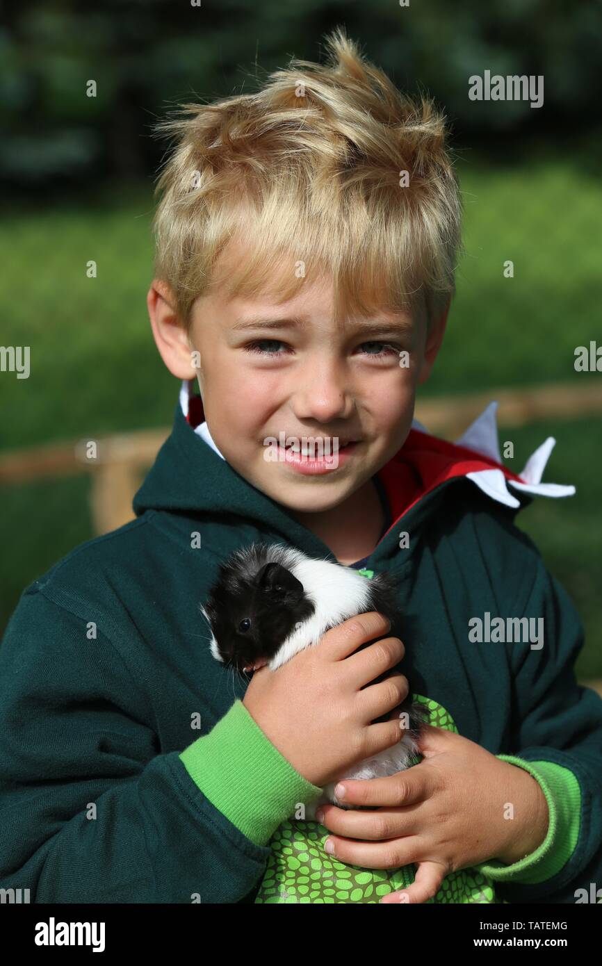 Boy hugging pigs hi-res stock photography and images - Alamy