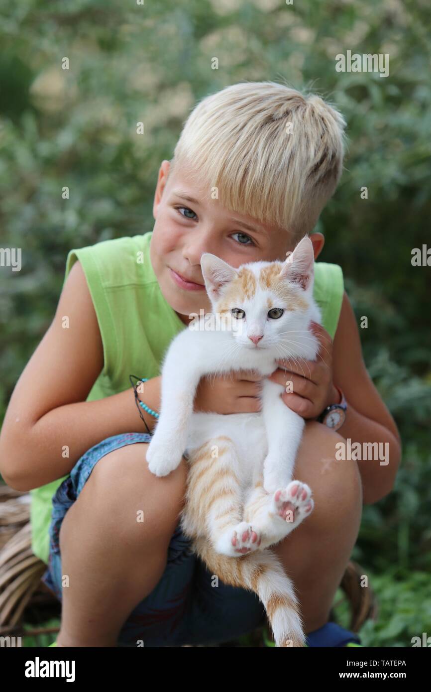 Boy carrying cat hi-res stock photography and images - Alamy