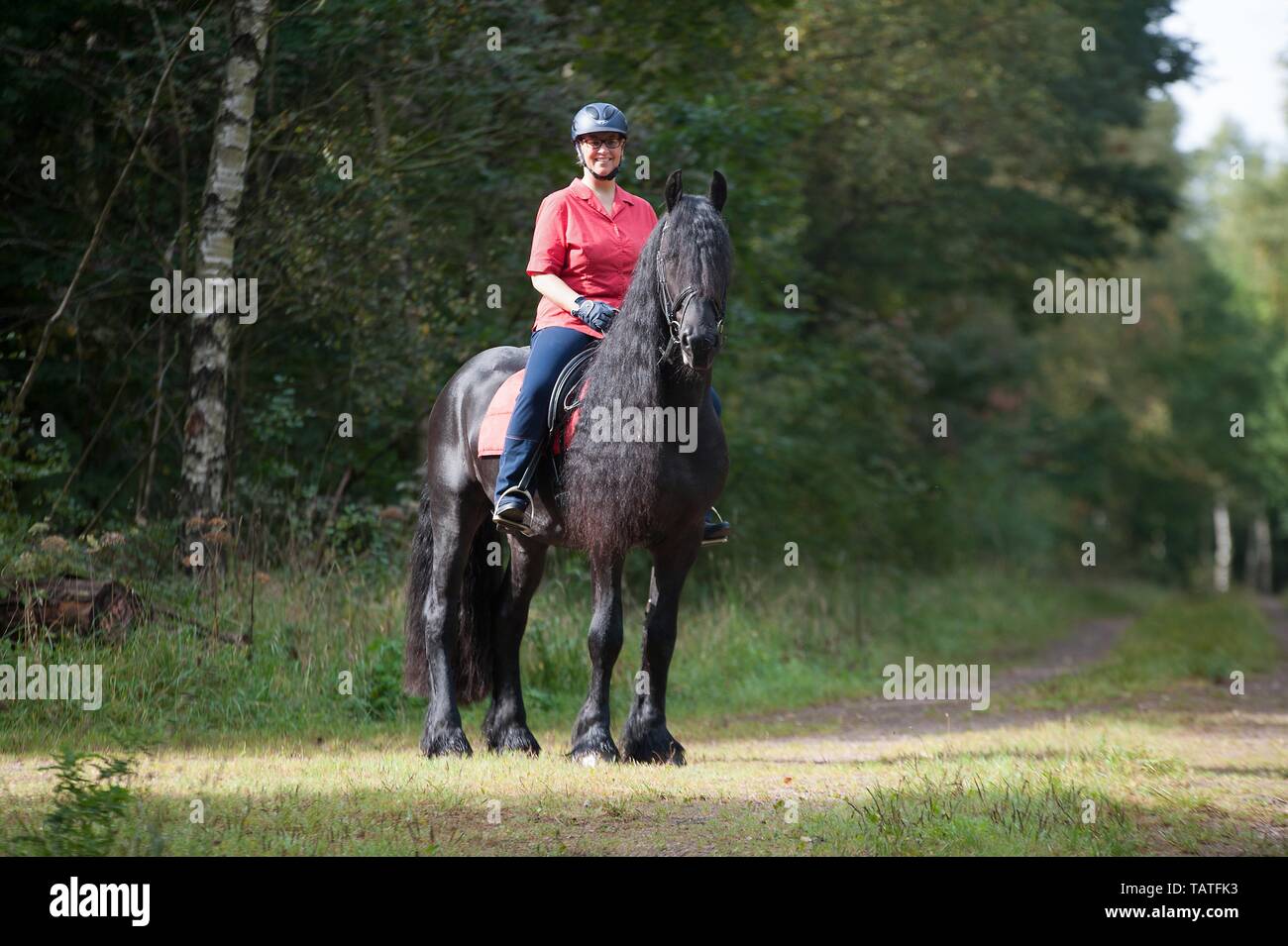 Woman riding horse through forest hi-res stock photography and images ...