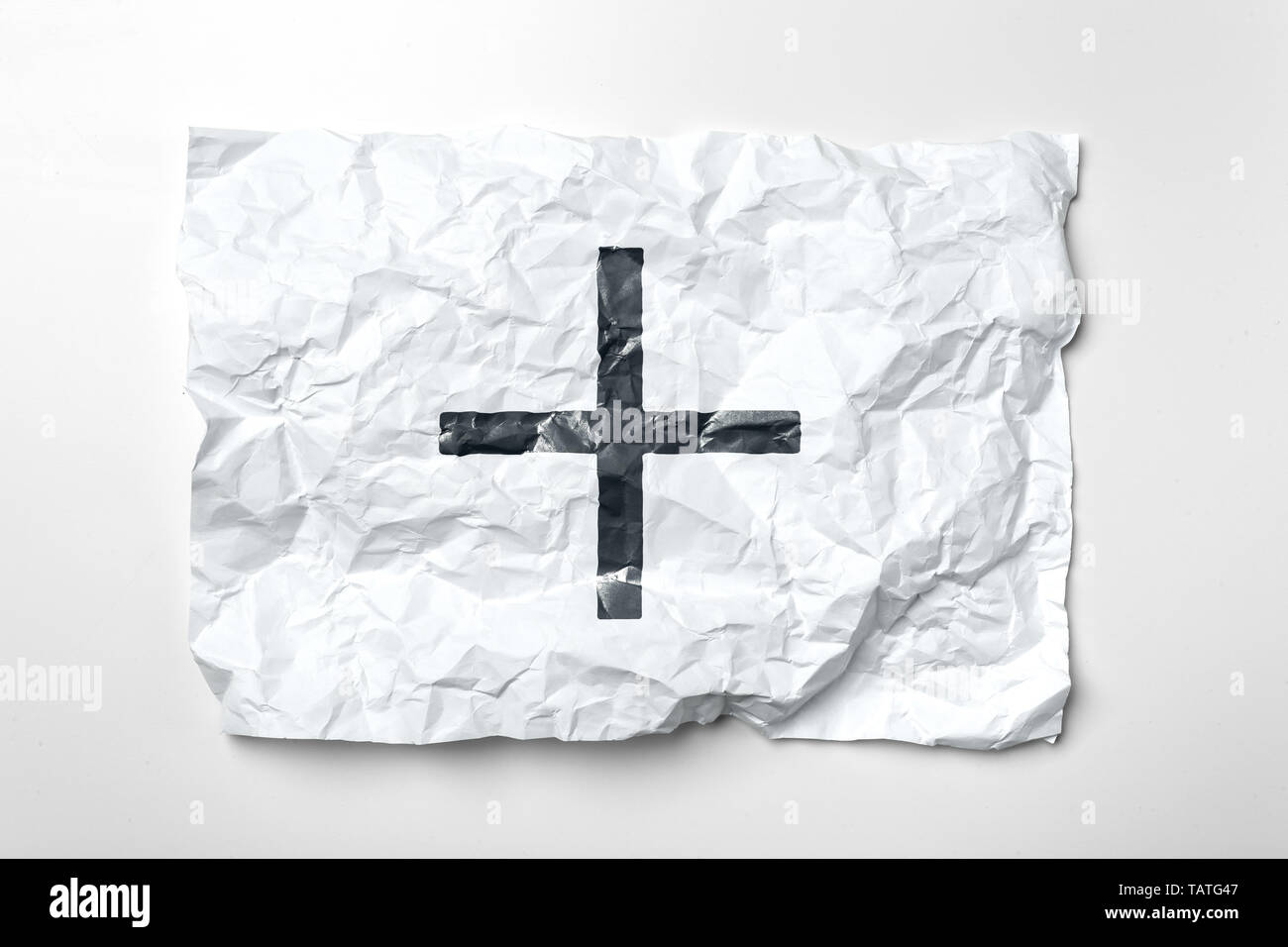 Plus sign on a crumpled paper Stock Photo - Alamy