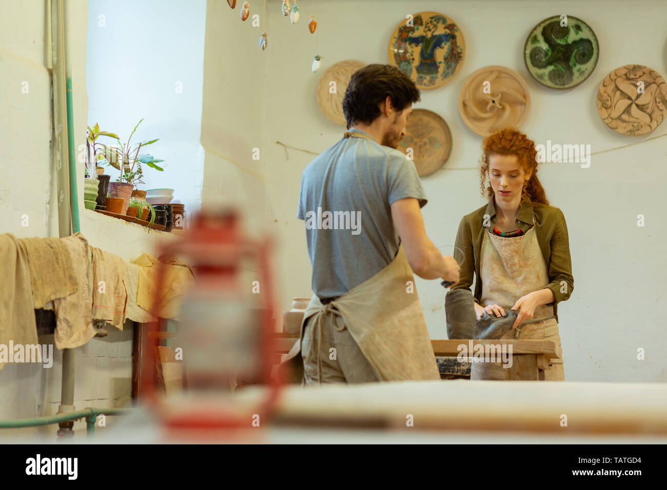 Professional pottery master. Focused skilled pottery workers staying ...