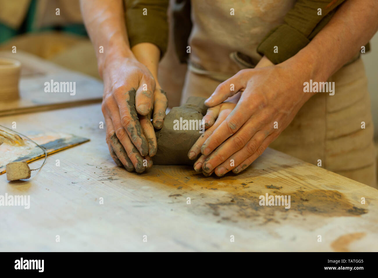 Covered in clay. Romantic lovely couple having masterclass in pottery ...