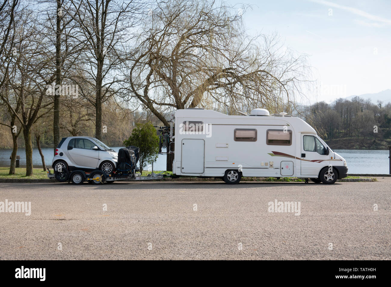 mobile home with a car trailer behind Stock Photo - Alamy