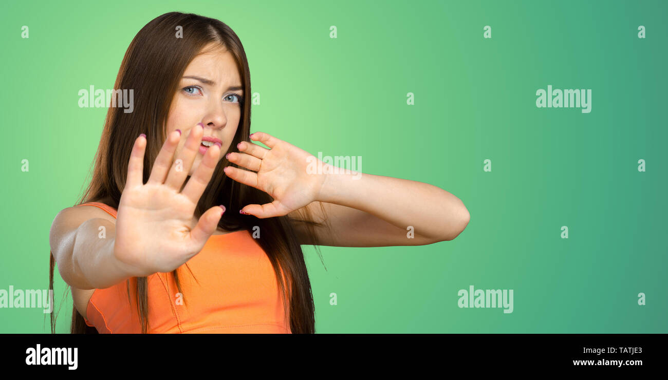 Young casual woman showing refusal hand sign Stock Photo - Alamy