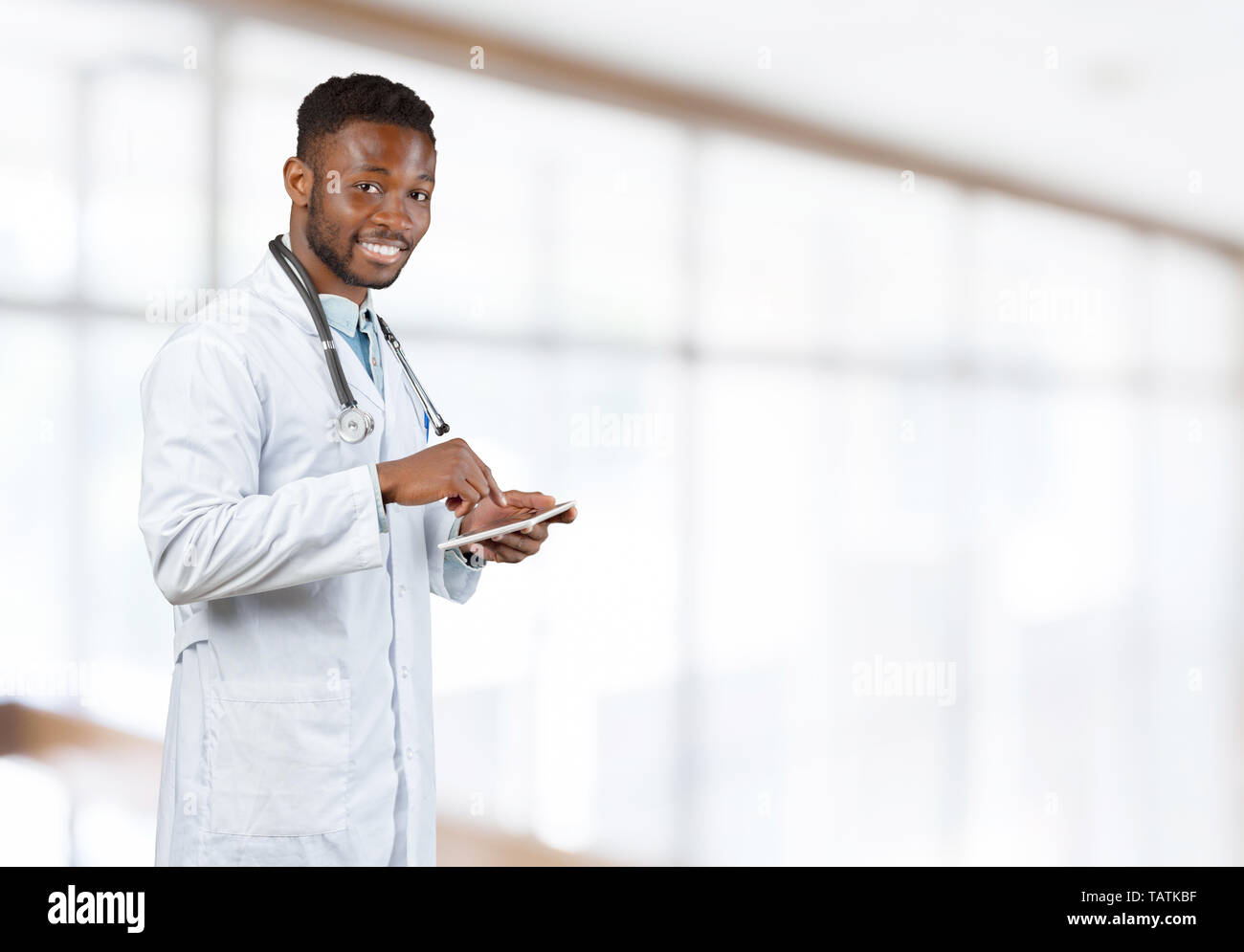 African american doctor with a stethoscope standing against blurred ...