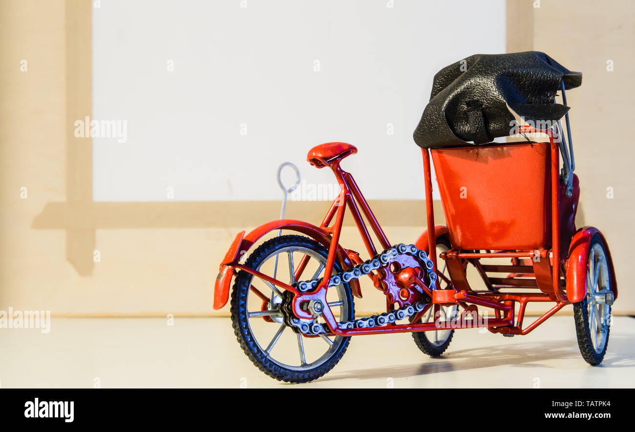 red color metal tricycle toy pedicab Stock Photo - Alamy