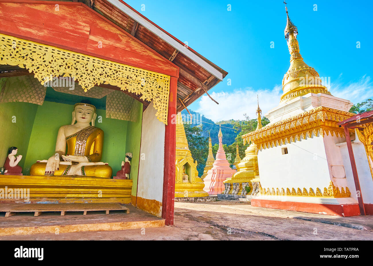 The shrine with ornate statue of Buddha among the stupas of Nget Pyaw ...
