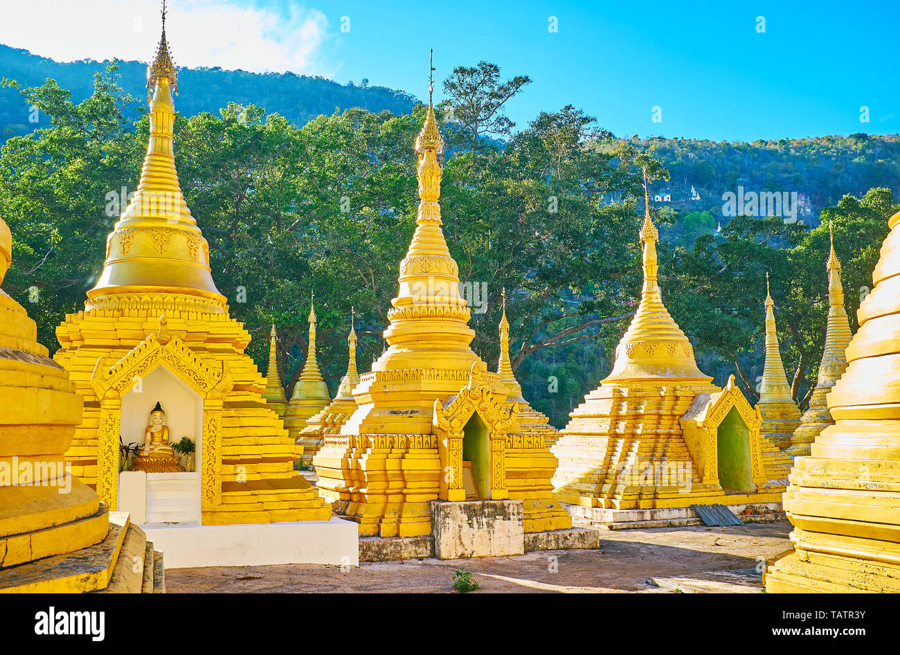 The shiny golden pagodas of Nget Pyaw Taw Paya with ornate carved ...