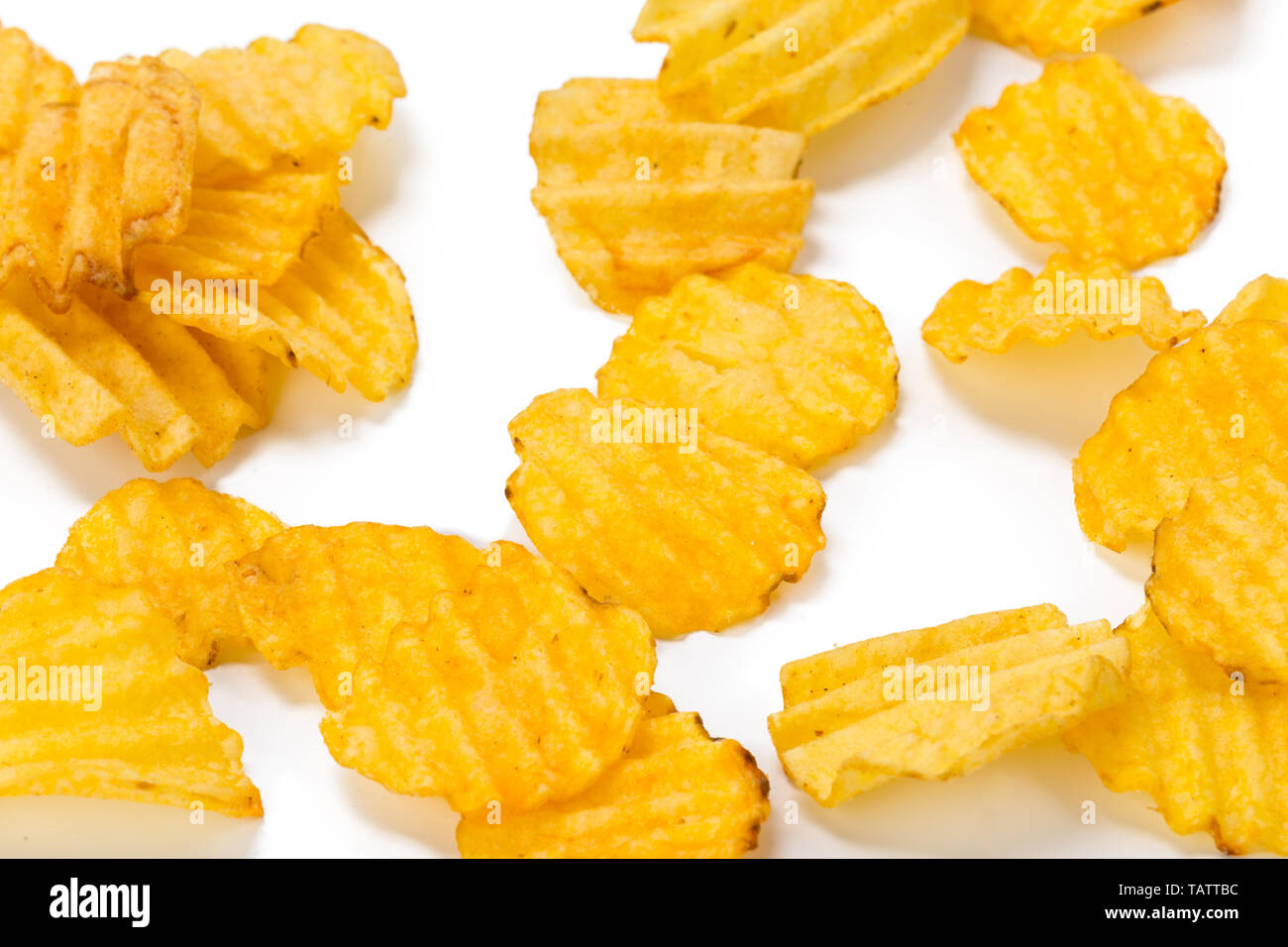 yellow potato chips isolated on white Stock Photo - Alamy