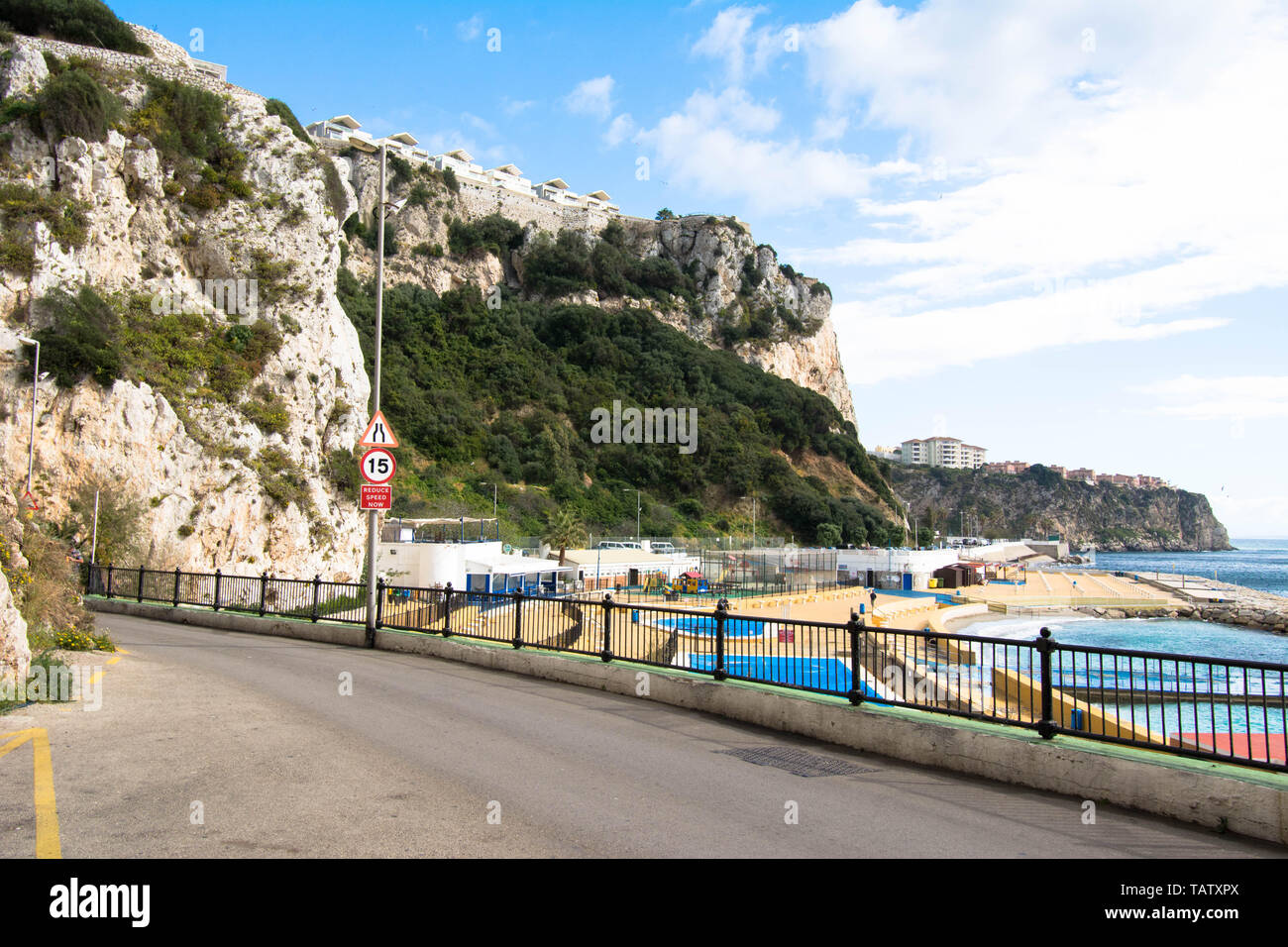 Gibraltar Coast Ocean sea water rocks rock rail railings road path sign ...