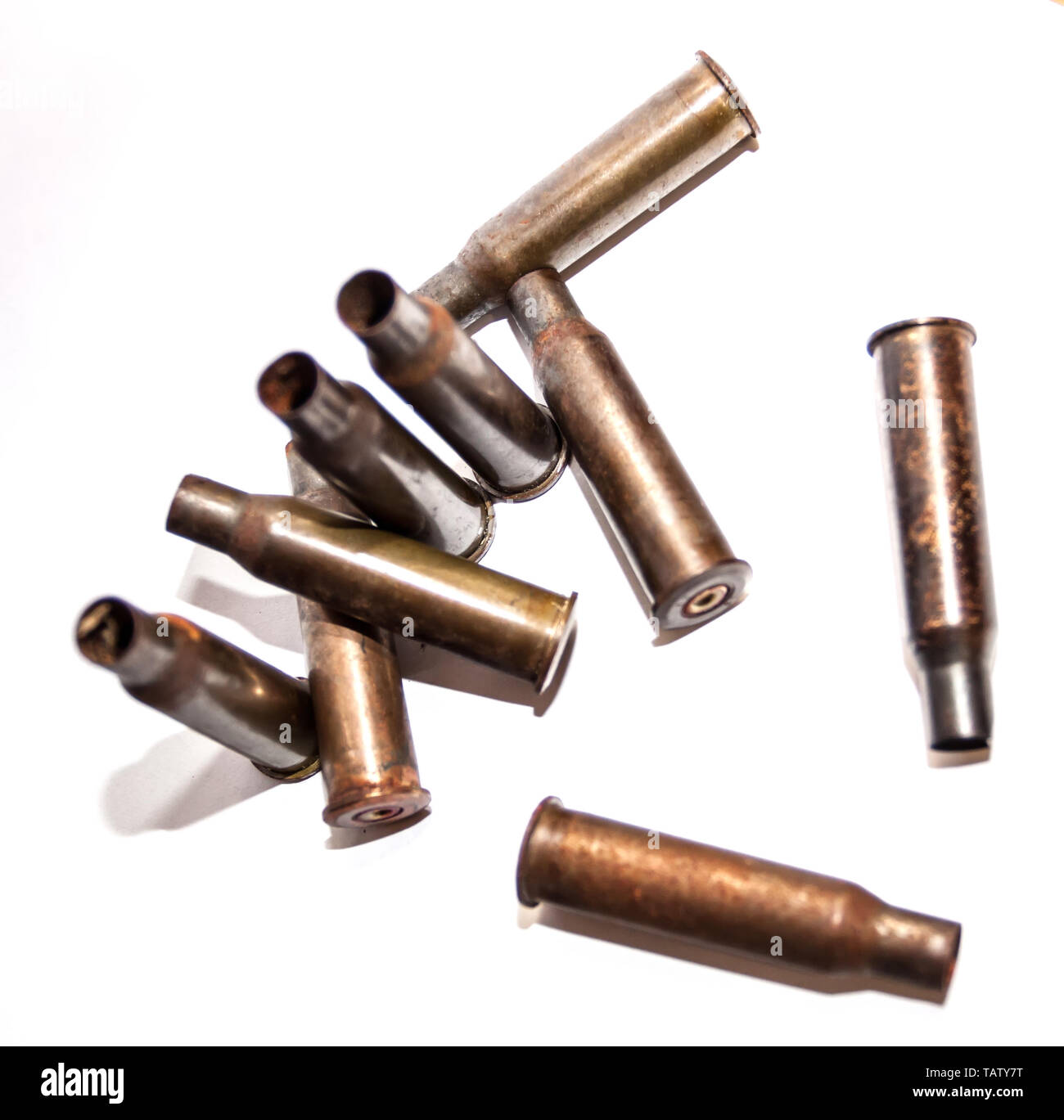 Empty bullet shells on a white background Stock Photo - Alamy