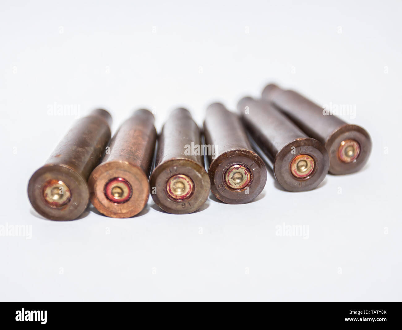Empty bullet shells on a white background Stock Photo - Alamy