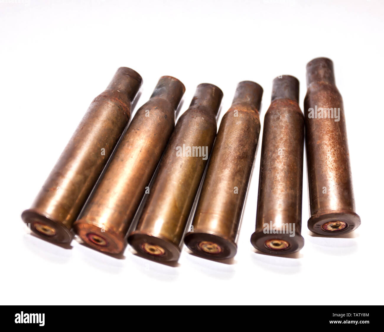 Empty bullet shells on a white background Stock Photo - Alamy