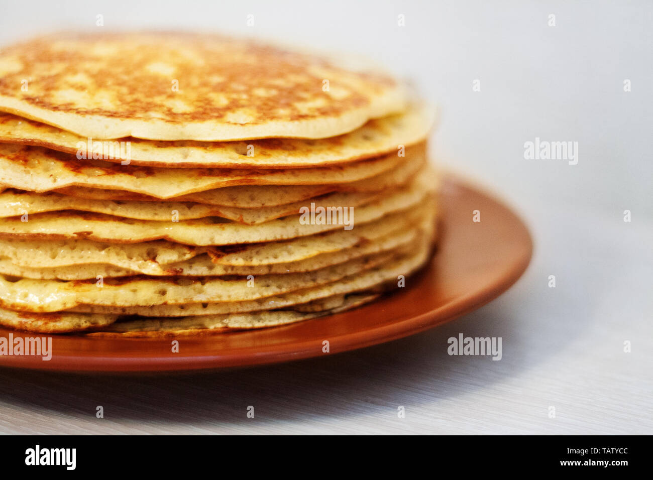 Homemade pancakes in a clay plate on a white background Stock Photo - Alamy
