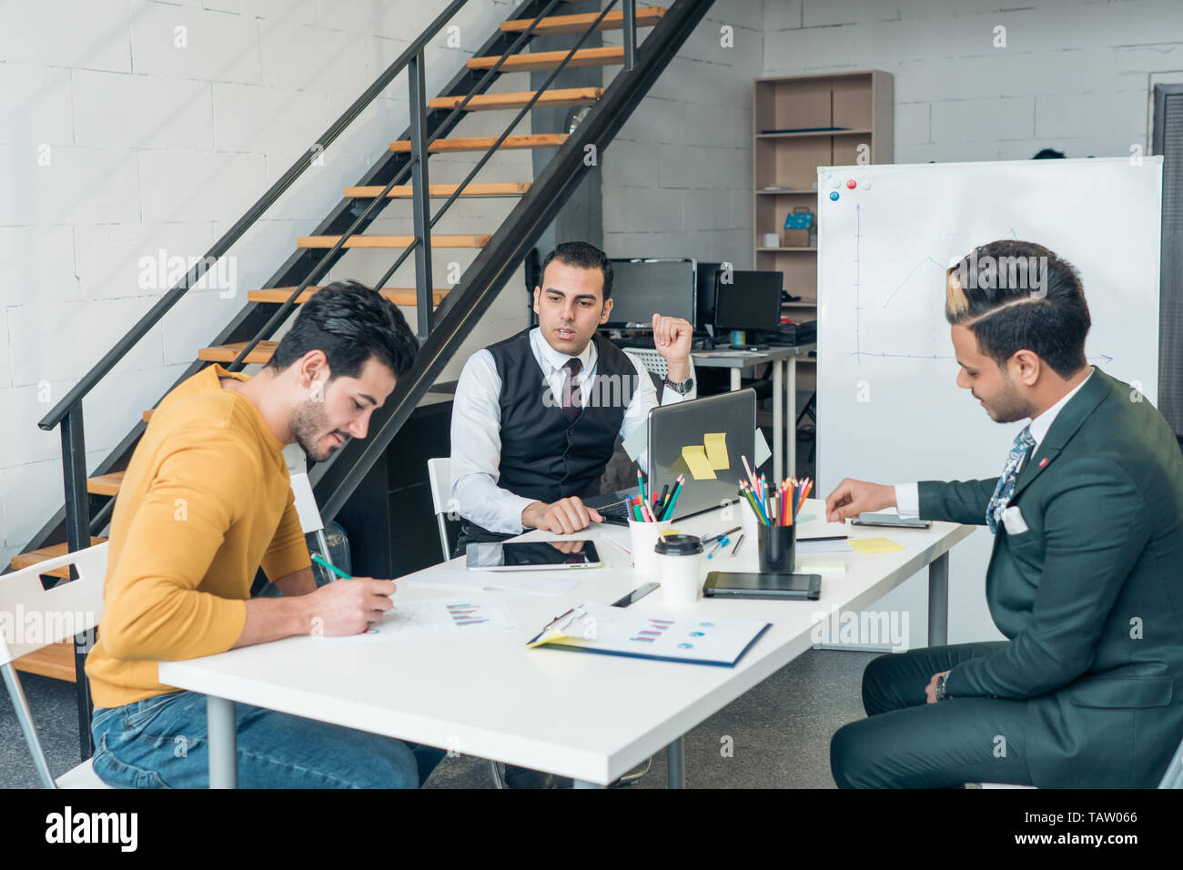 Business communication between young businessmen in a modern office ...