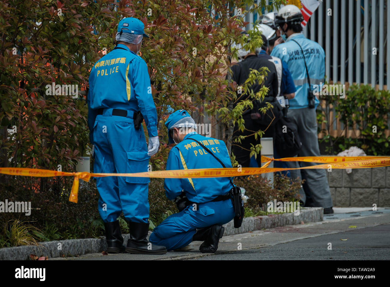 Forensic police officers from Kanagawa prefecture search for evidence ...
