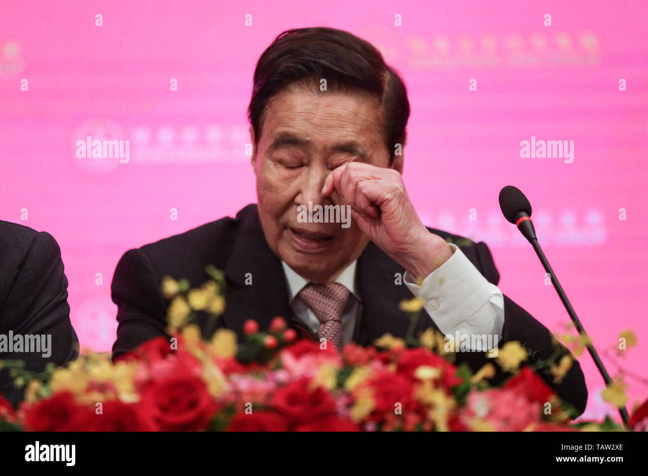 Lee Shau-kee rubs his eyes at a press conference addressing his ...