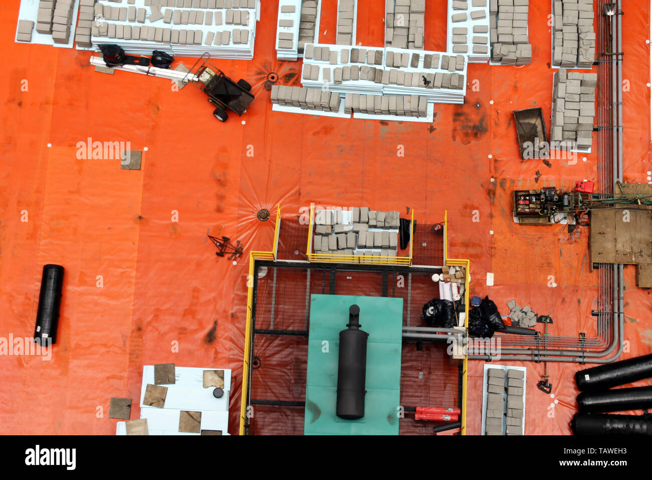 Boxes, pipes and other clutter on the orange roof of a building in ...
