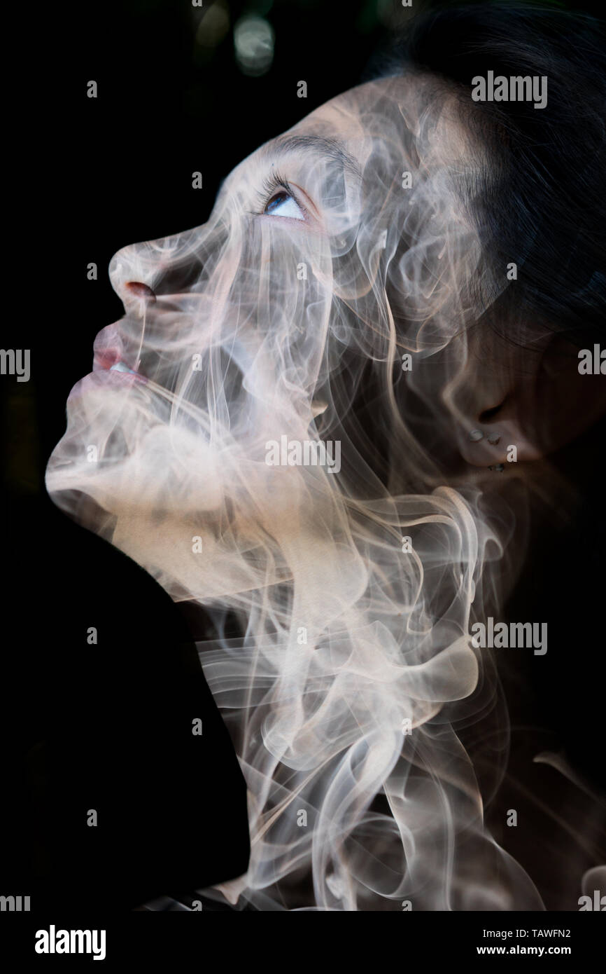 She hides behind layers of smoke Stock Photo - Alamy