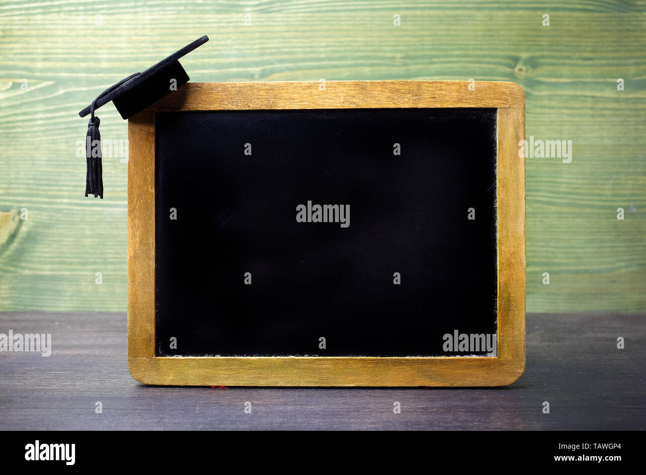 black chalkboard with a graduation cap hanging on the corner Stock ...