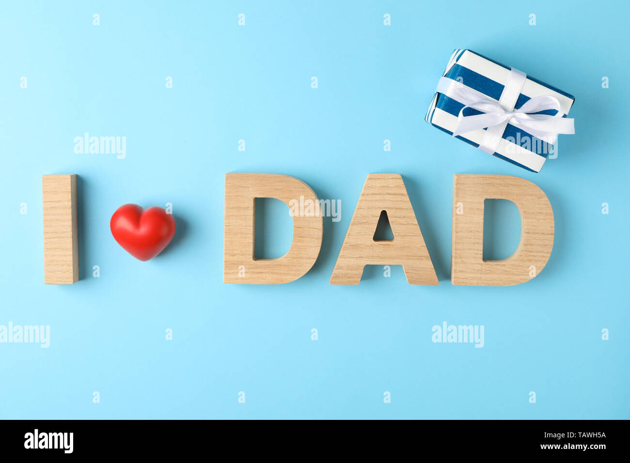 Inscription I love Dad made with wooden letters and red decorative ...